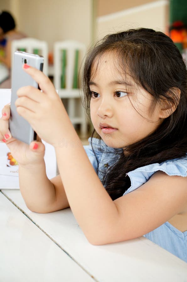 Happy Asian Child Touching Smart Phone Stock Photos - Free & Royalty ...