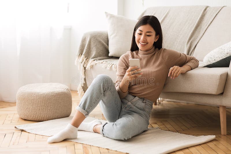 Happy Asian Girl Messaging On Phone At Home Stock Image Image Of Couch Female 152826441