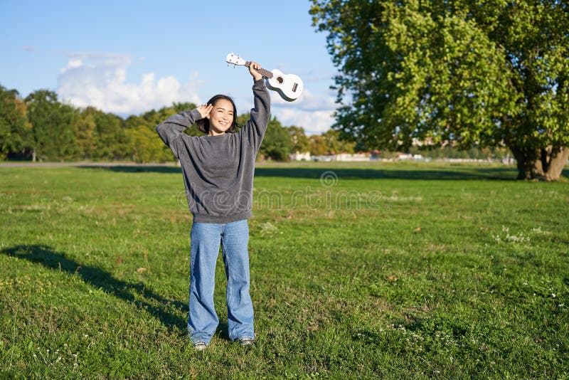 Happy Asian Girl Musician With Ukulele Feeling Carefree Enjoying