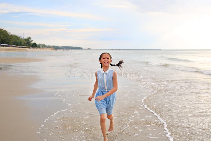 Happy Asian Girl Running on the Sandy Beach Stock Photo - Image of ...