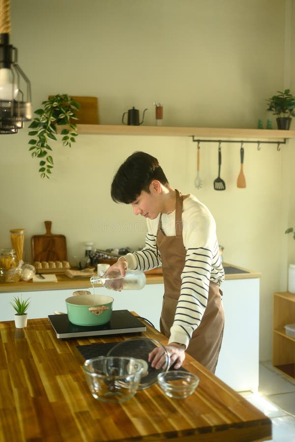 Happy Asian Man Cooking at Home with Fresh Ingredients Stock Photo ...