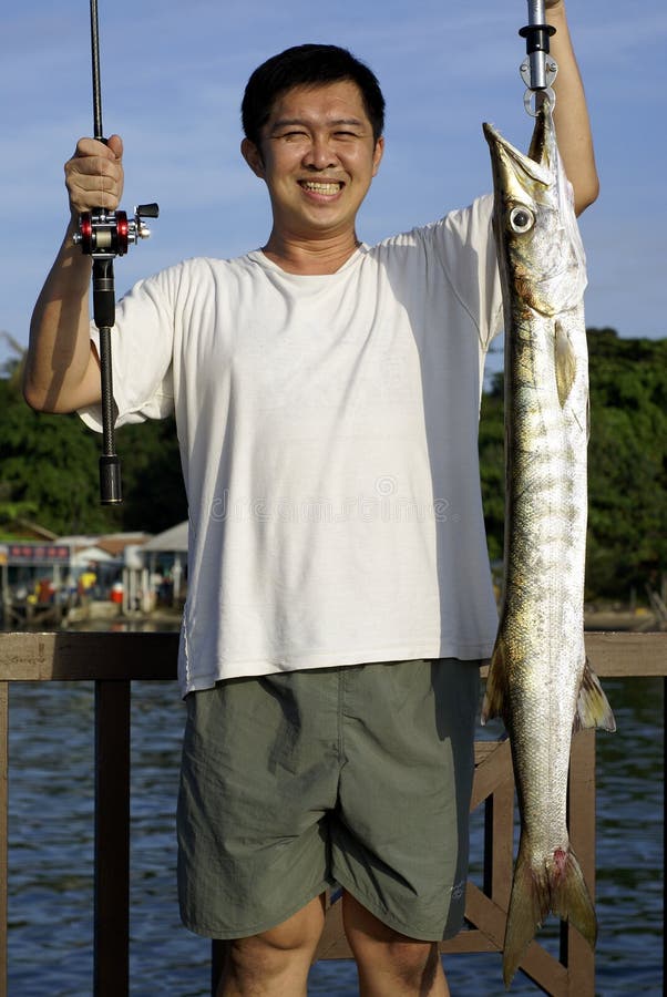 Happy asian man with fish stock photo. Image of outdoors - 7564728