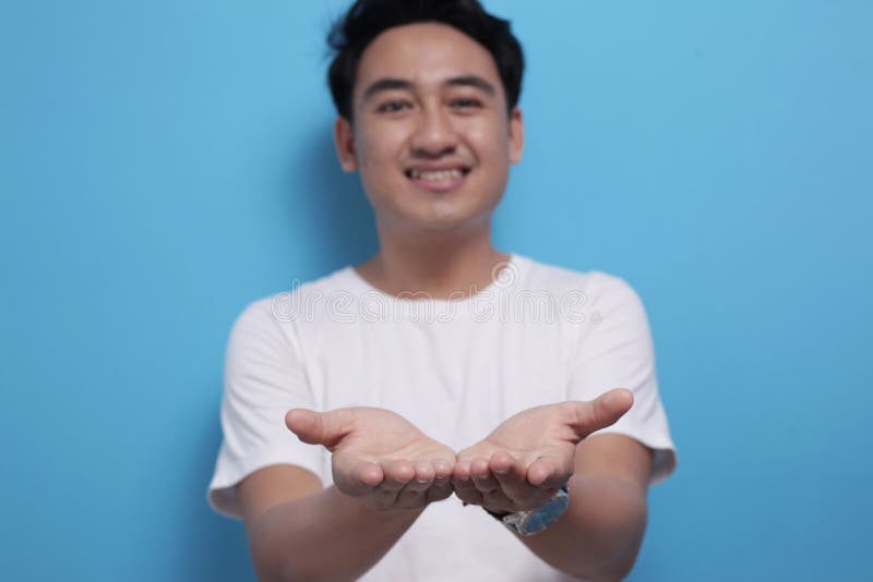 Happy Asian Man Smiling while Offering Something on His Empty Hands ...