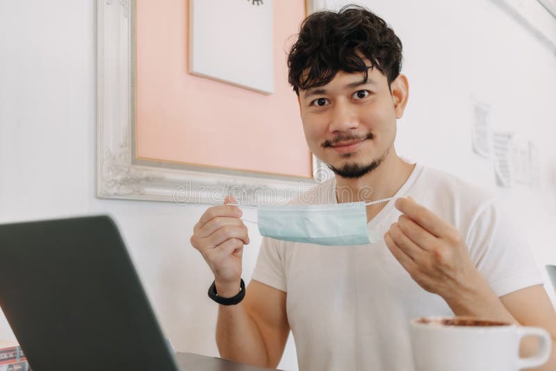 Happy Man Work in a Cafe Taking Off Mask and Smile. Stock Image - Image ...