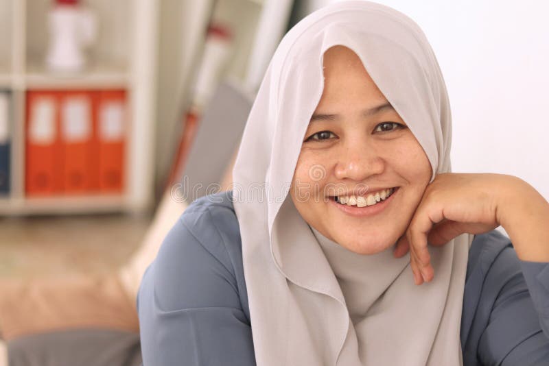 Happy Asian Muslim Woman Smiling Cheerful While Looking At Camera Stock
