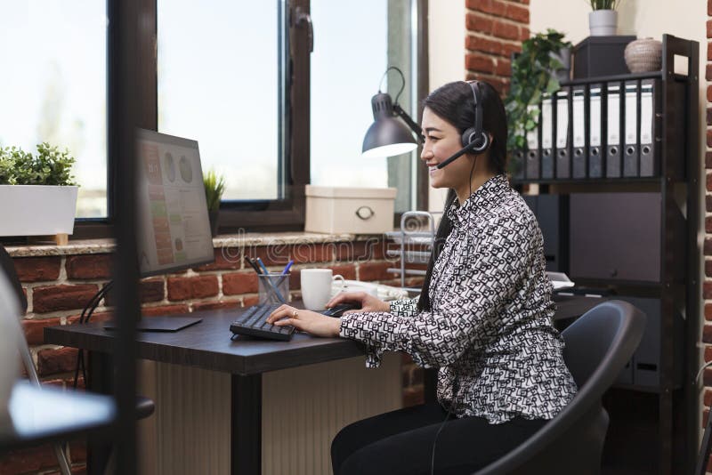 Happy Asian Sales Agent with Headset on Call with Potential Product ...