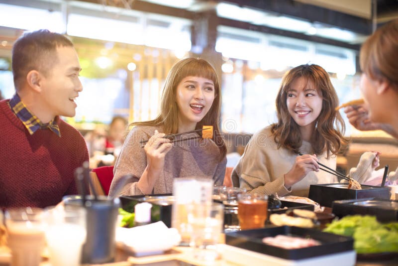 Happy Young Group Eating in the Restaurant Stock Image - Image of ...