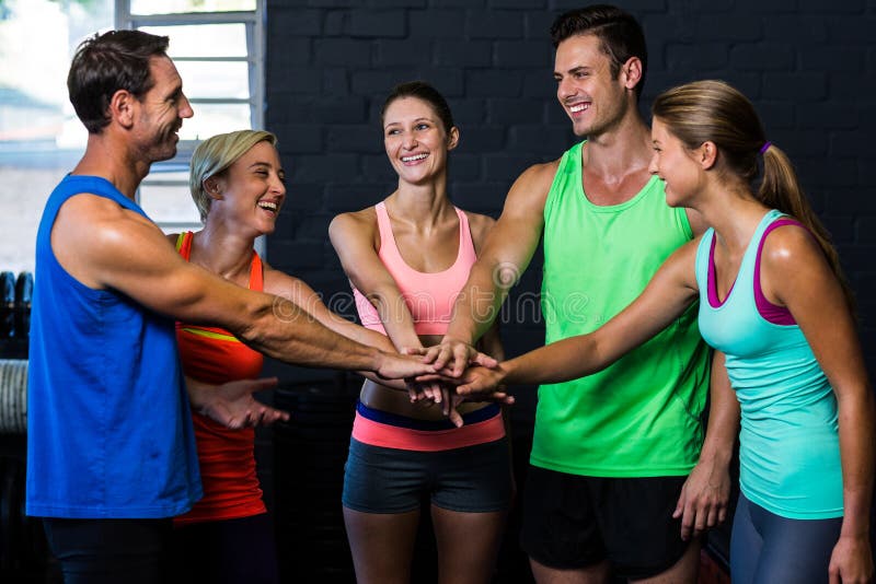 Happy Athletes Putting Hands Together in Gym Stock Photo - Image of ...