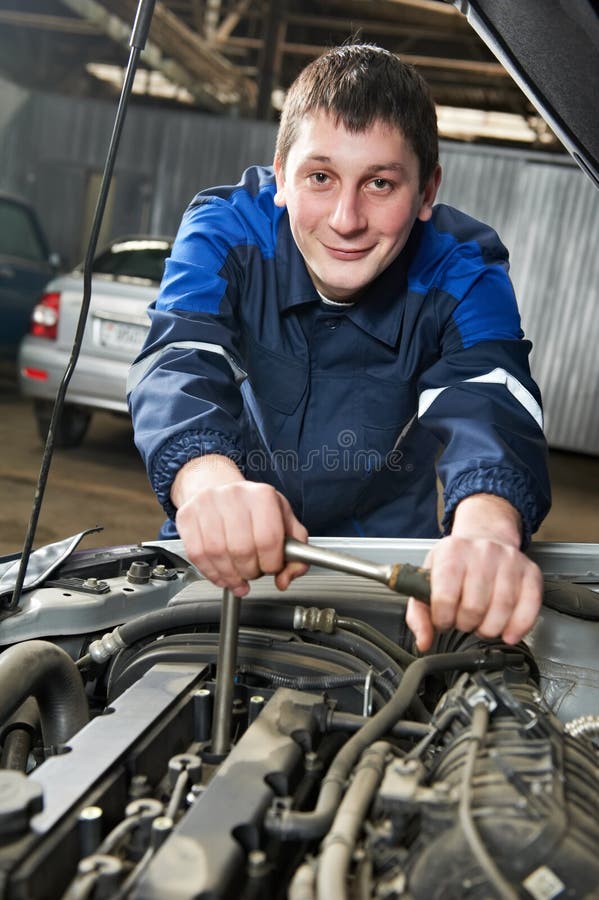 Happy Automotive Mechanic at Work with Wrench Stock Photo - Image of ...
