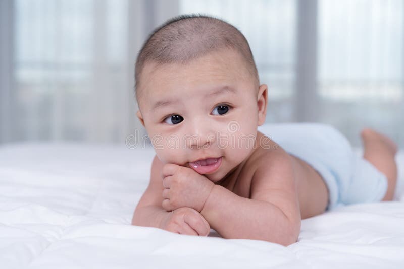 Happy baby on a bed stock image. Image of playful, happy - 157543053