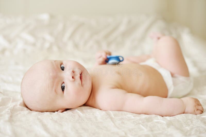 Happy baby on the bed stock photo. Image of little, care - 154322036
