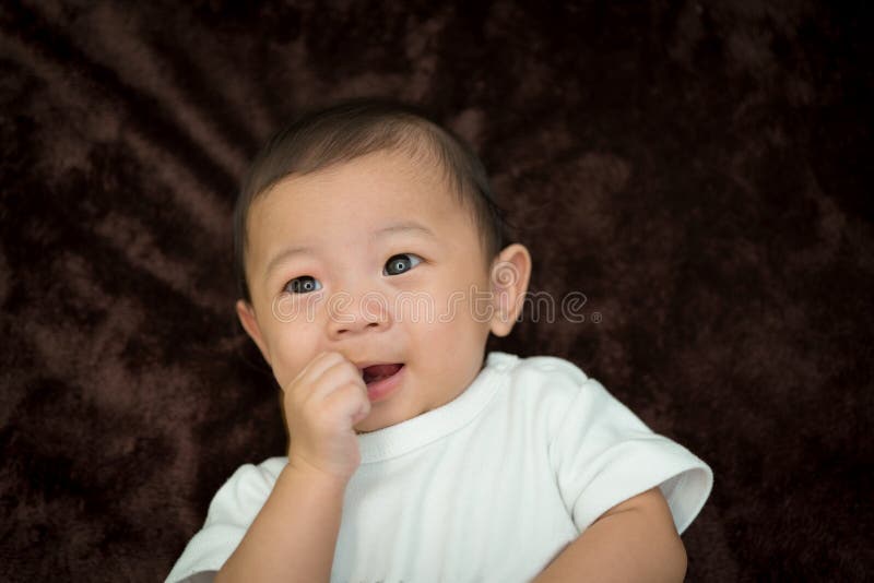 Happy Baby Boy Lying on Brown Sheet Stock Image - Image of playful ...