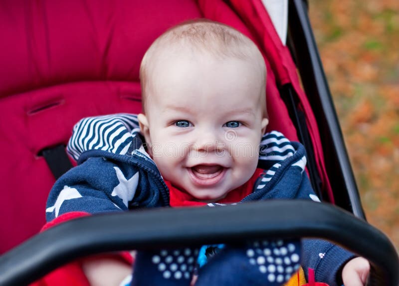 Happy Baby Boy Sitting in a Stroller Stock Photo - Image of beautiful ...