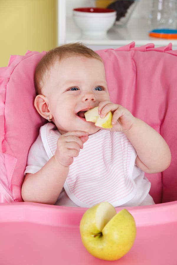 Happy baby eating apple stock photo. Image of beautiful - 49561026