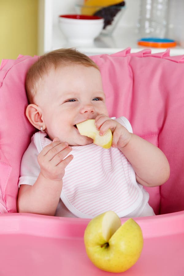 Happy baby eating apple stock image. Image of caucasian - 49776985