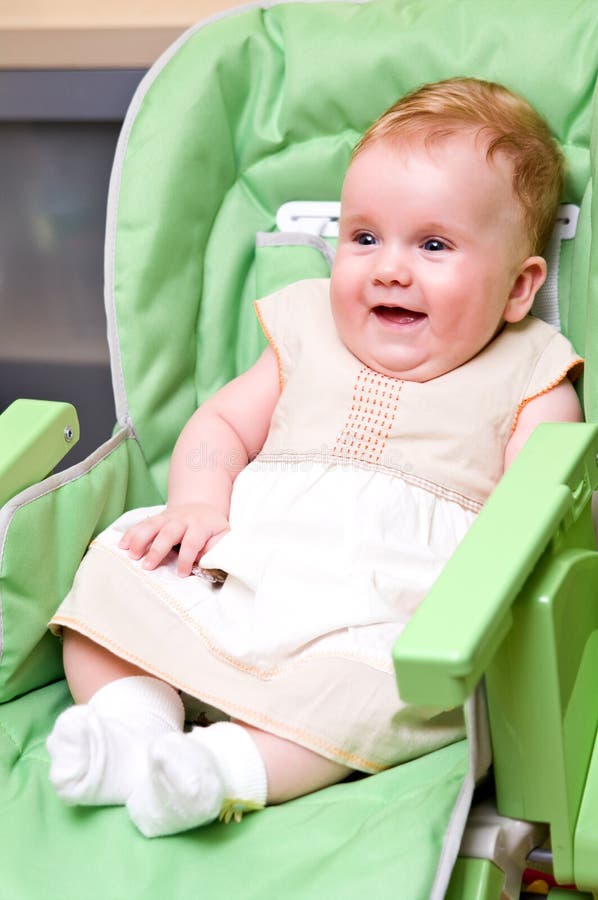 Happy baby in high chair stock image. Image of belts - 15728277