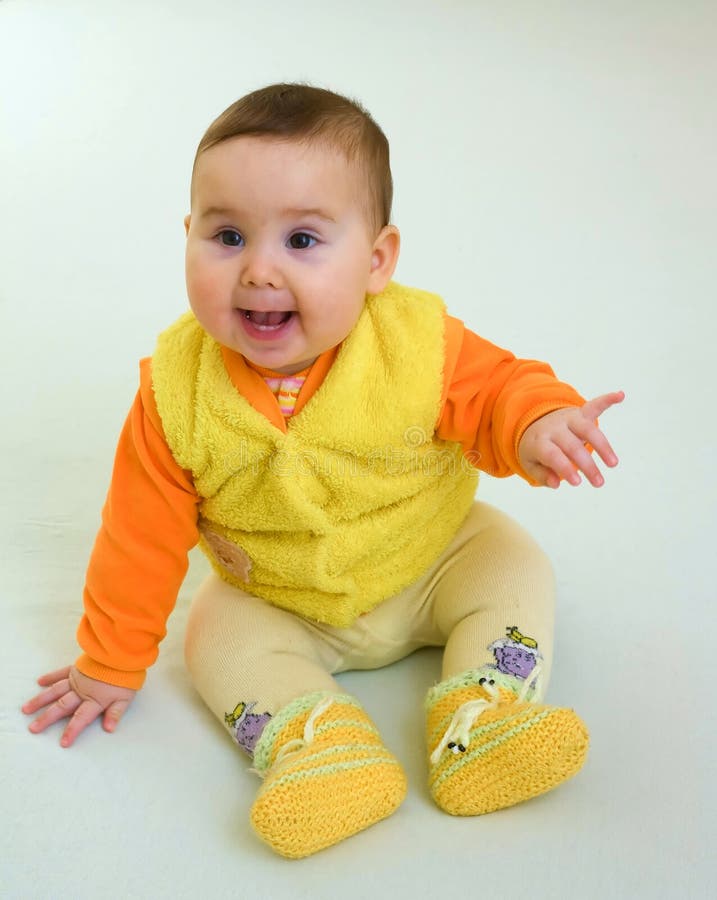 Happy baby in orange dress stock photo. Image of expression - 13864494