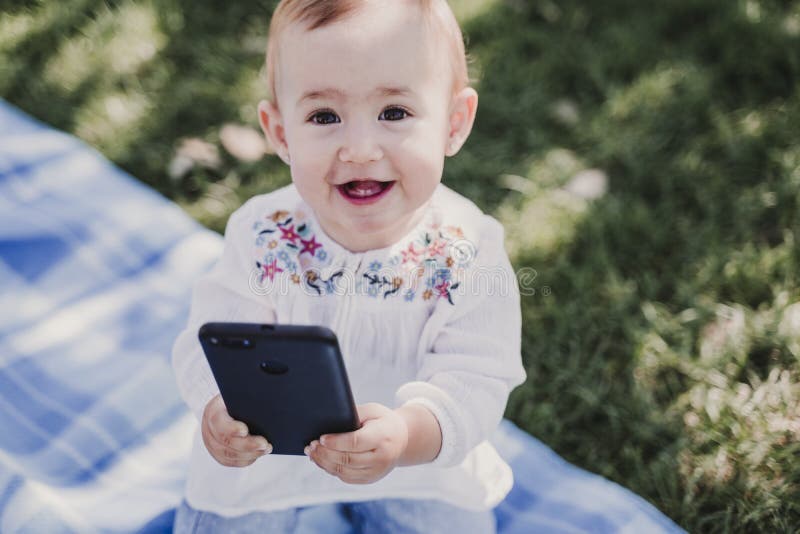 Happy Baby Using Mobile Phone Outdoors. Technology Concept Stock Image ...