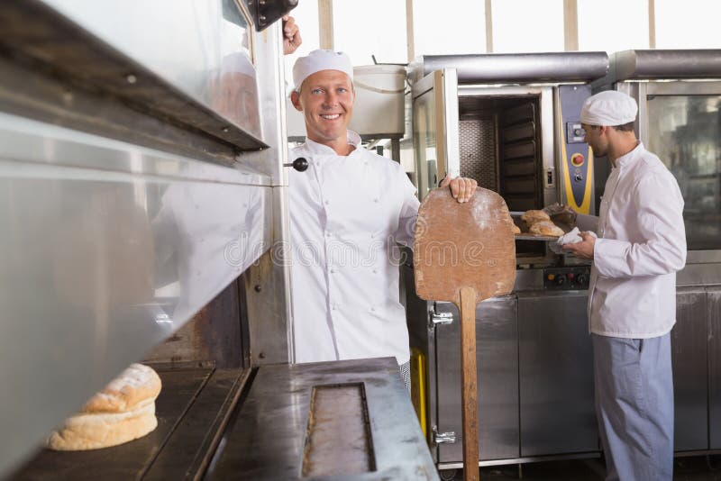 Happy Baker Smiling at Camera Stock Photo - Image of holding, kitchen ...