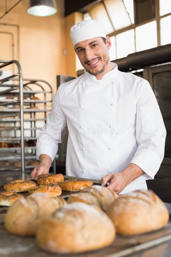 Happy Baker Taking Out Fresh Bagels Stock Photo - Image of business ...