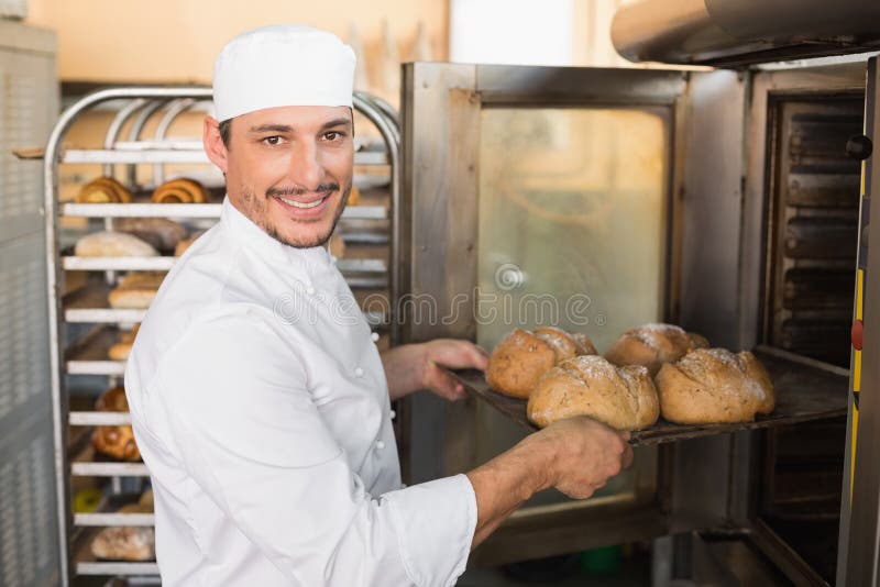 Happy Baker Taking Out Fresh Loaves Stock Photo - Image of business ...