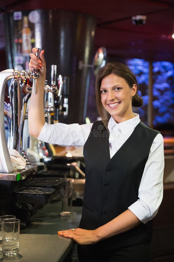 Happy Barmaid Pulling a Pint of Beer Stock Photo - Image of staff, beer ...