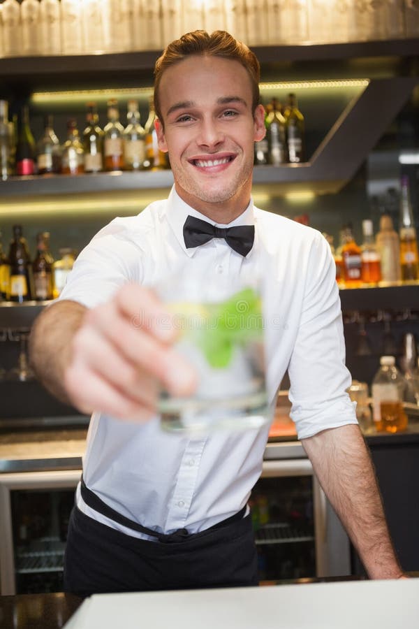 Happy Bartender Offering Cocktail To Camera Stock Image - Image of ...