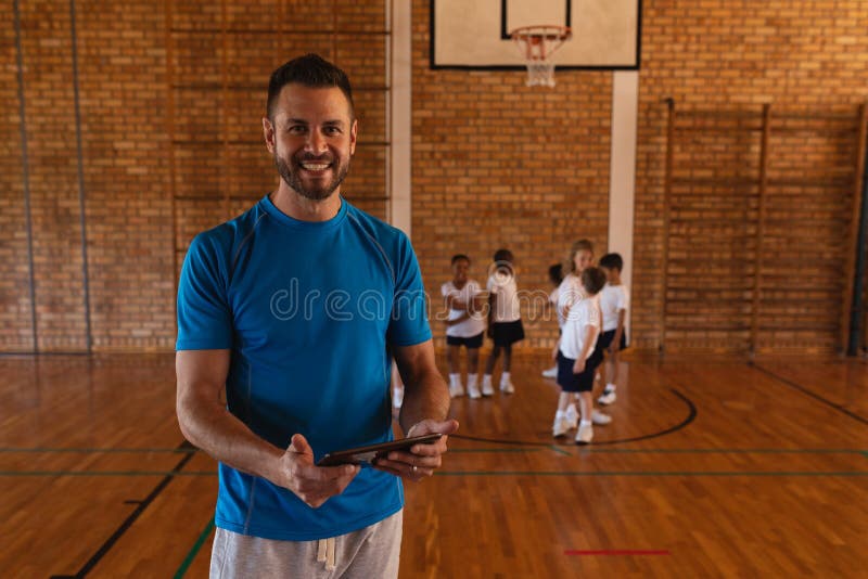 Happy Basketball Coach Using Digital Tablet at Basketball Court in ...