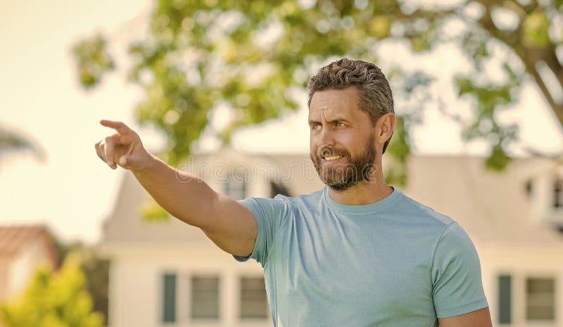 Happy Bearded Man Looking Forward and Pointing Finger, Directing Stock ...