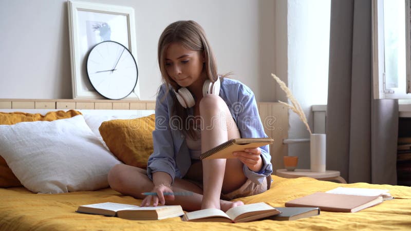 Happy Beautiful Student Girl Making Notes in Paper Notebook, Lying on ...