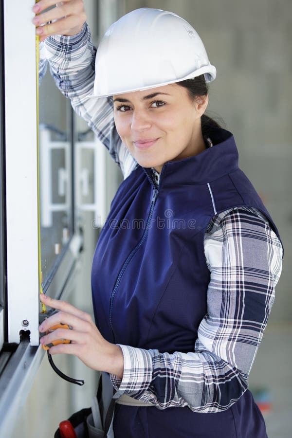 Happy Beautiful Woman Builder with Tape Measure Stock Photo - Image of ...