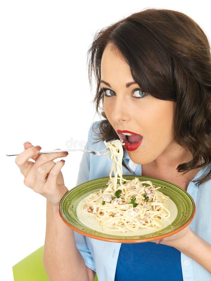 Happy Beautiful Young Woman Eating A Plate Of Spaghetti Carbonara Pasta