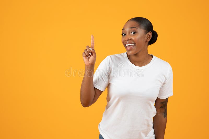 Happy Black Lady Pointing Finger Upwards on Yellow Studio Background ...
