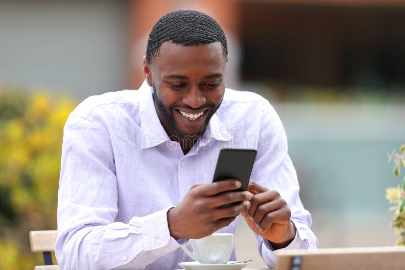 Happy Black Man Checking Mobile Phone in a Bar Stock Photo - Image of ...