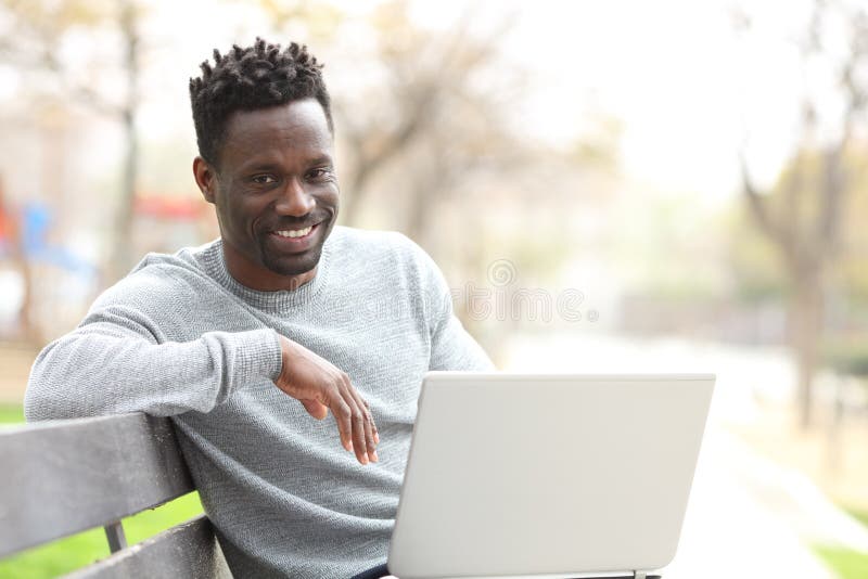 Happy Black Man with Laptop Looking at Camera Stock Photo - Image of ...