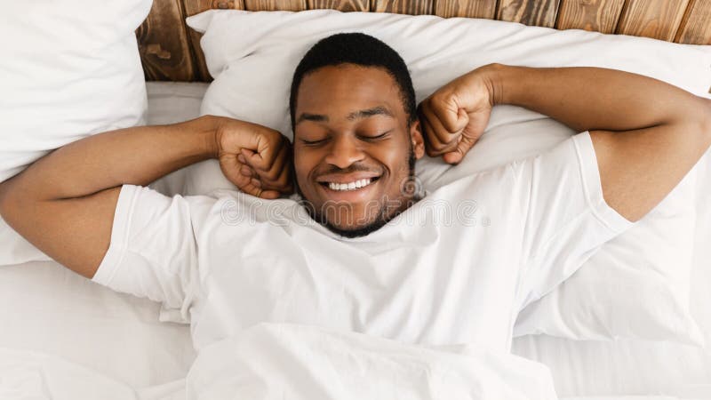 Happy Black Man Waking Up Lying in Bed Indoor, Top-View Stock Image ... Happy Black Man Waking Up Lying in Bed Indoor, Top-View Stock Image ...