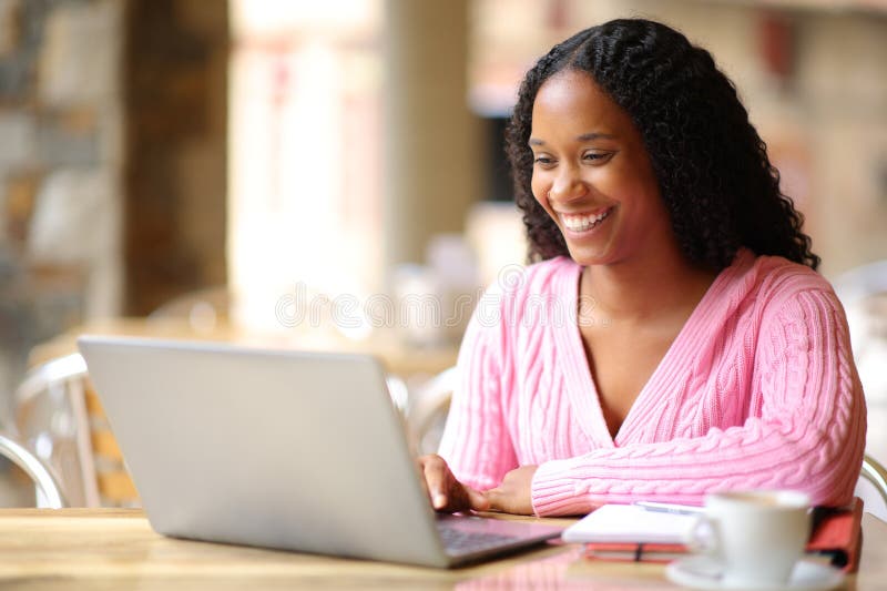 Happy Black Student Using Personal Computer in a Bar Stock Image ...