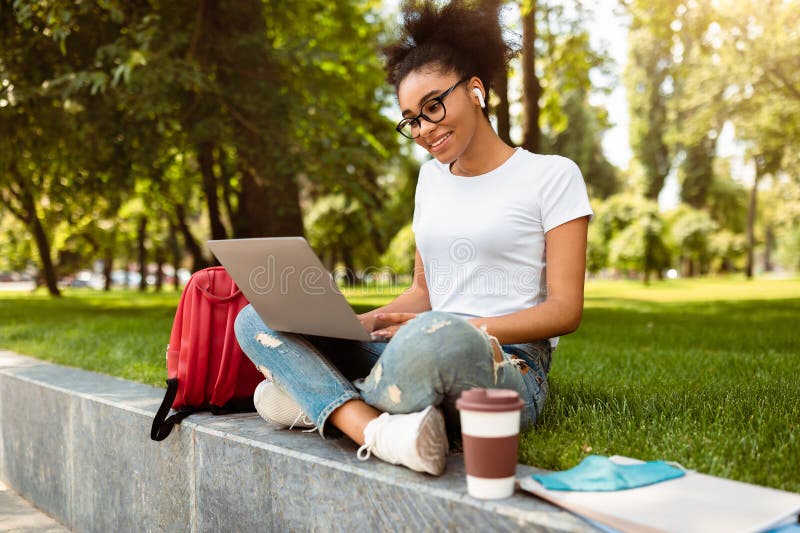 Happy Black Student Watching Lecture on Laptop in Park, Side-View Stock ...
