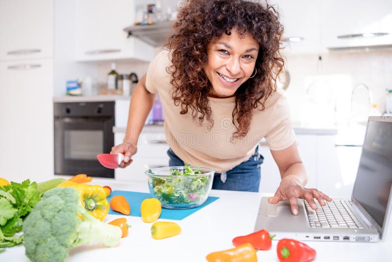 Happy Black Woman Learning To Cook at Home with Online Courses Stock ...
