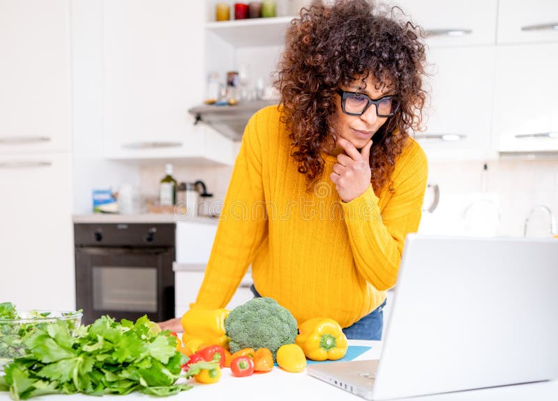 Happy Black Woman Learning To Cook at Home with Online Courses Stock ...