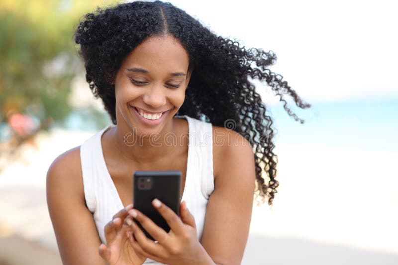 Happy Black Woman Using Phone on the Beach Stock Photo - Image of girl ...