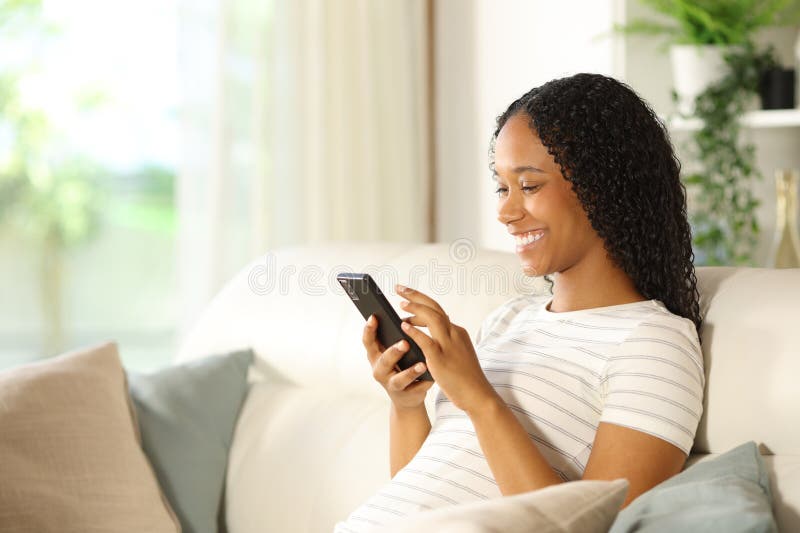 Happy Black Woman Using Smart Phone at Home Stock Image - Image of ...