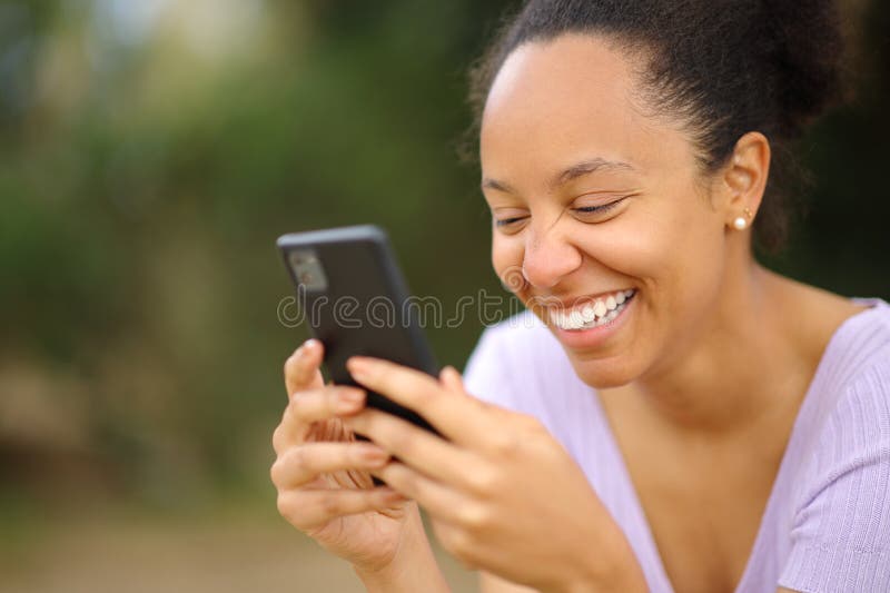 Happy Black Woman Using Smart Phone Laughing Stock Photo - Image of ...