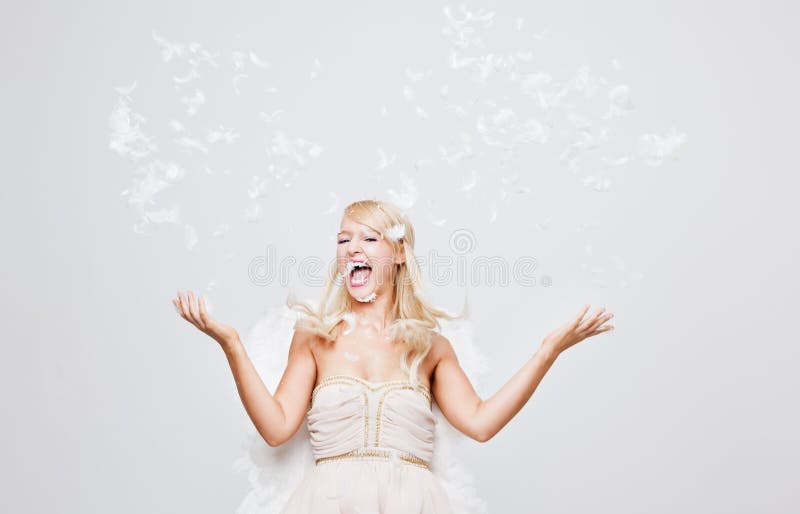 Happy Blonde Angel Throwing Feathers Stock Image - Image of vertical ...