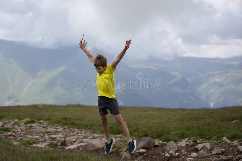 Happy Boy Against the Backdrop of a Mountain Landscape Stock Photo ...