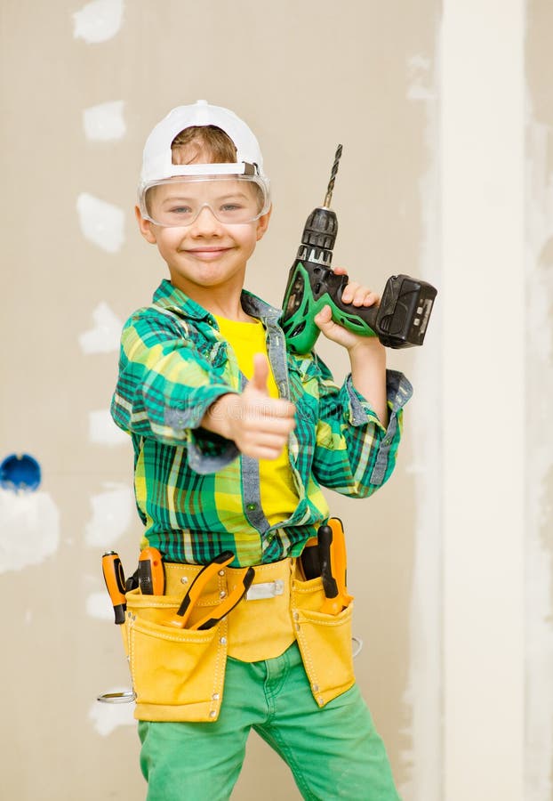Happy Boy with a Drill and Tool Belt Showing Thumbs Up Stock Image ...