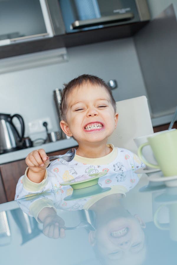 Happy Boy Eating Breakfast stock image. Image of male - 23297383