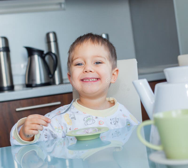 Happy Boy Eating Breakfast stock photo. Image of cornflakes - 23297454