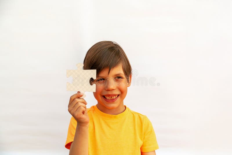 Happy Boy Holding Puzzle Piece in His Hands. a Game for the Development ...