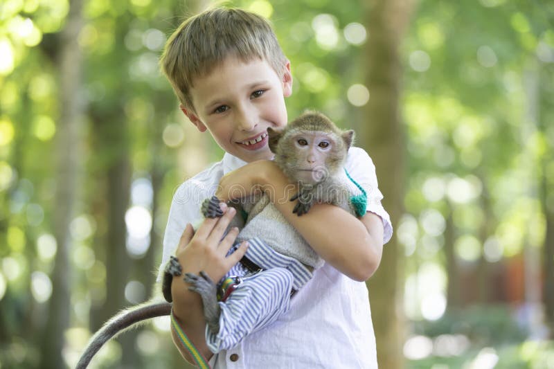 A Happy Boy Holds a Little Monkey Stock Image - Image of child, female ...